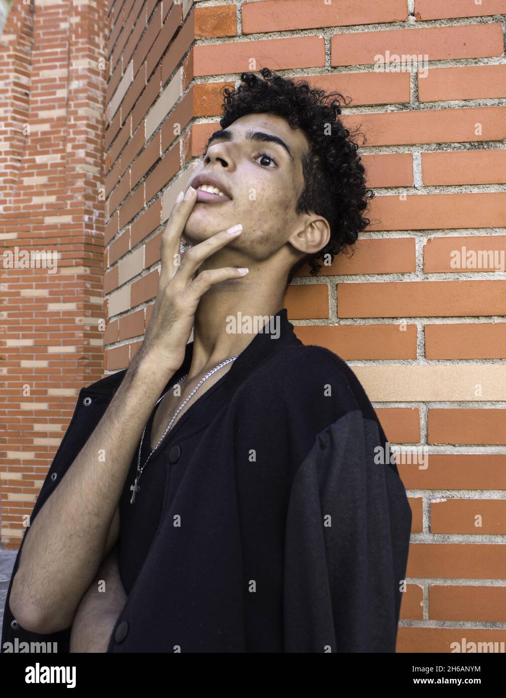 A young Hispanic male in a black outfit posing on the streets in Old ...