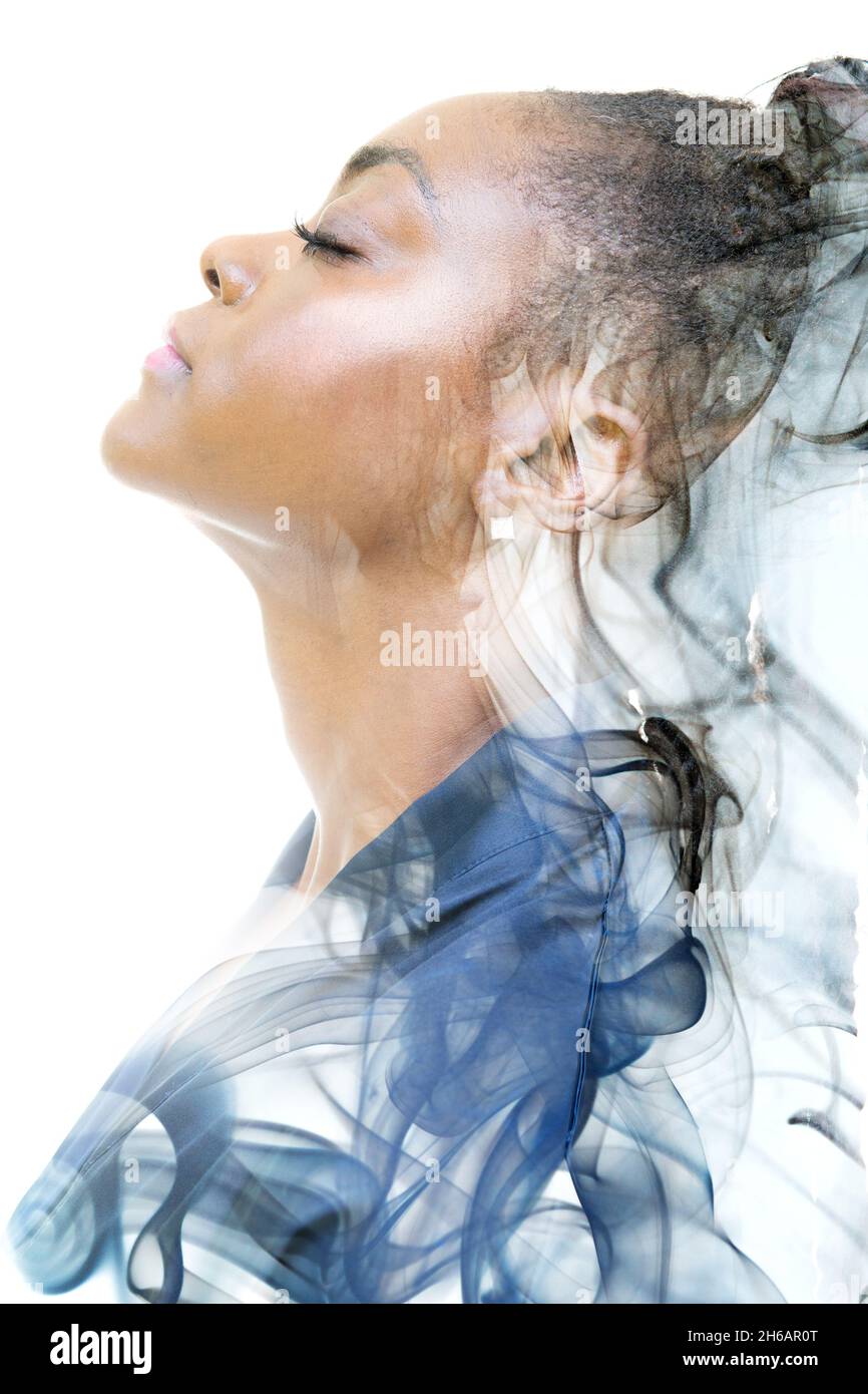 A profile portrait of a woman dissolving into smoke in a double ...