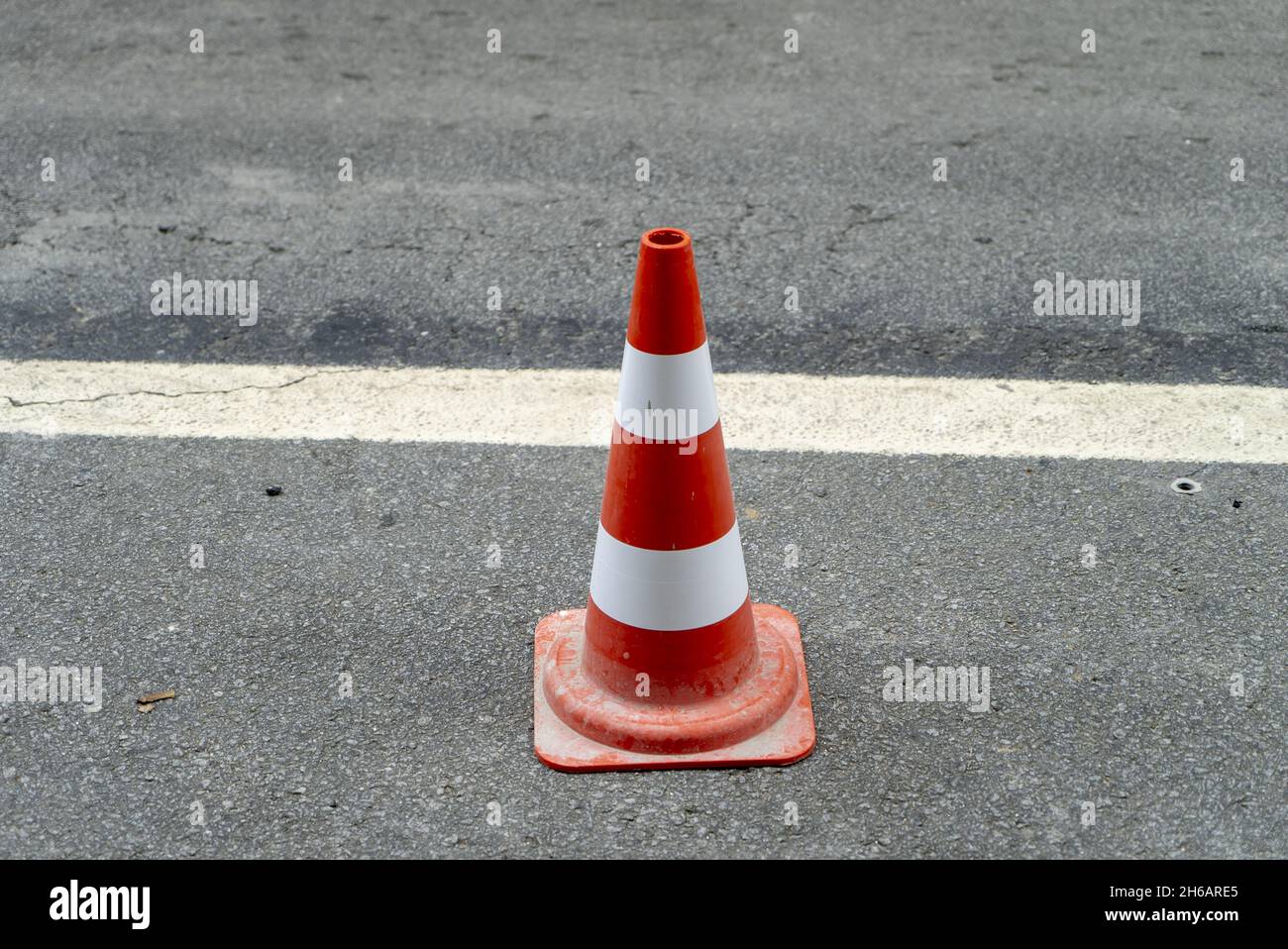 A red traffic cone on the street for a temporary diversion of traffic ...