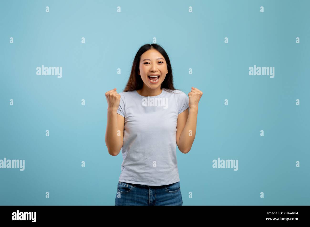 Young woman emotionally celebrating victory hi-res stock photography ...