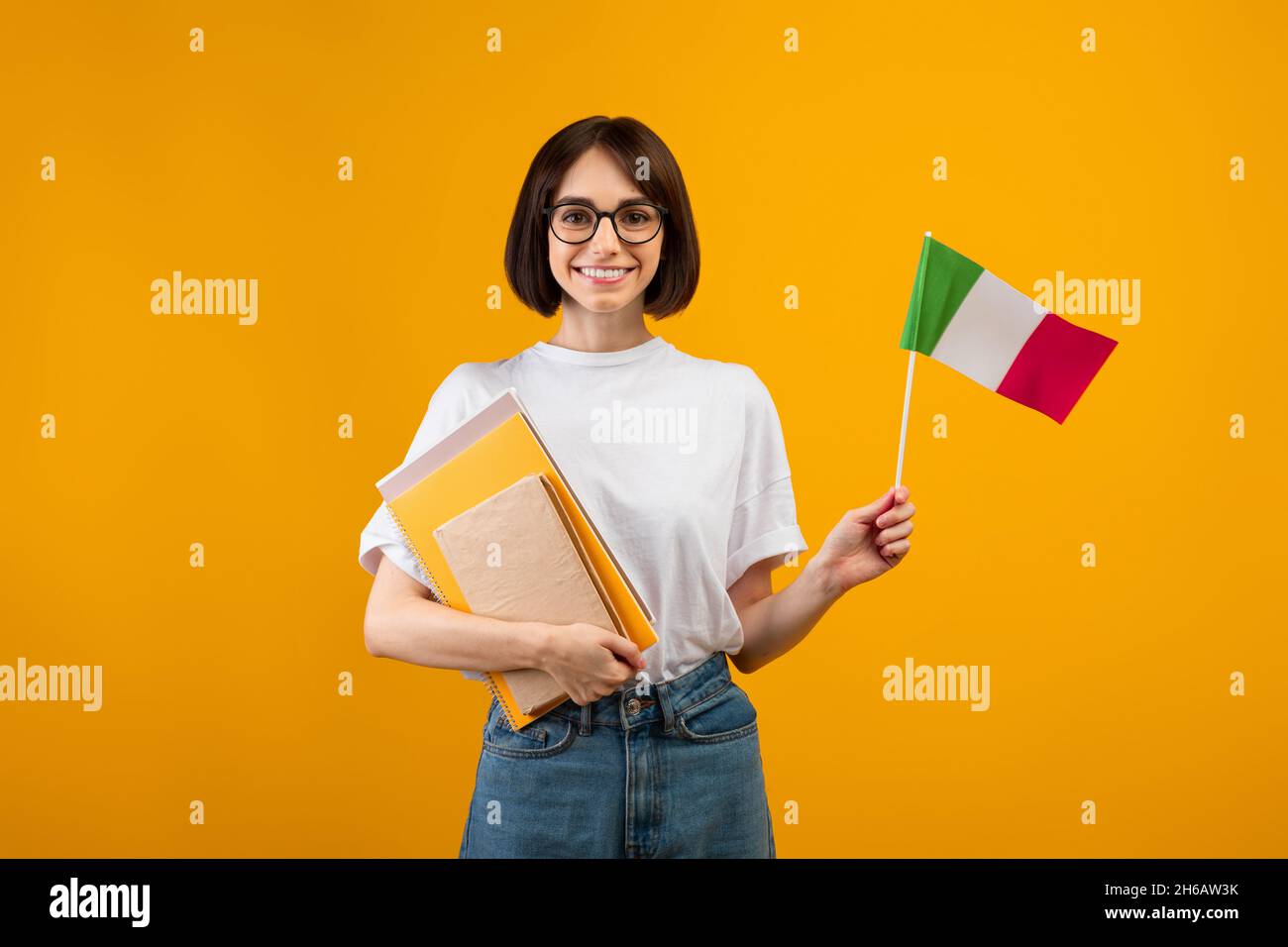 Learning Italian, student exchange and travel. Happy lady holding ...