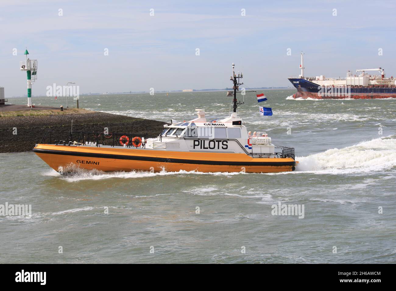 a pilot boat sails into the harbor of port city terneuzen in zeeland at ...