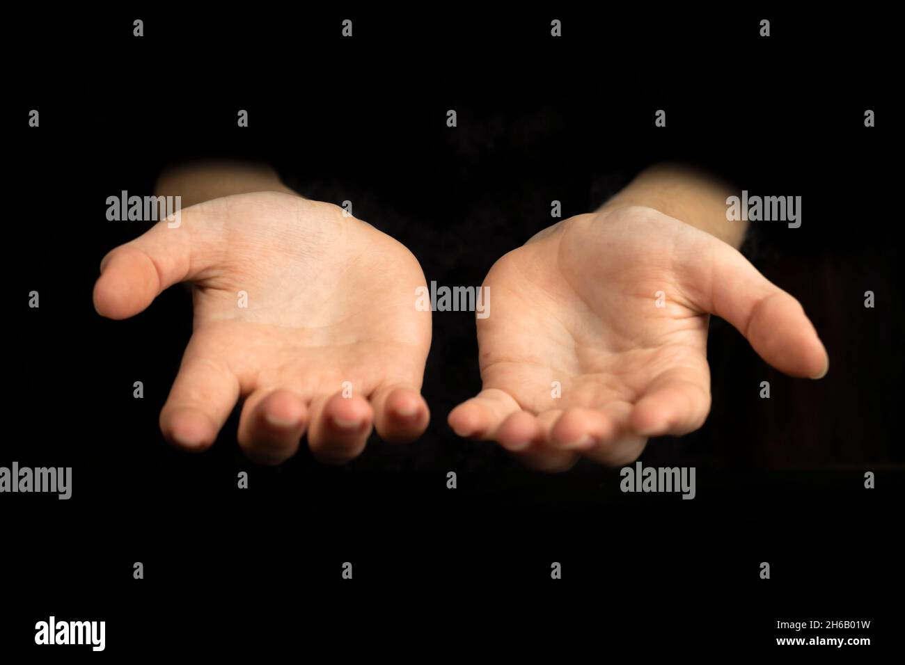 Empty hands with empty palms up isolated on a black background photo ...