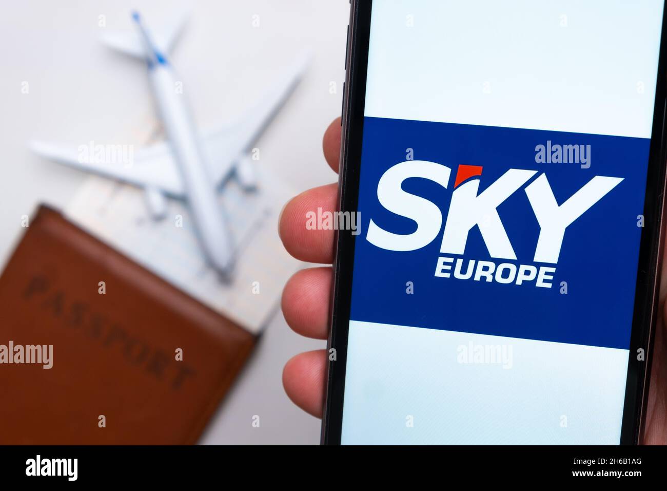 Sky Europe airlines company logo on the mobile phone screen in man hand ...