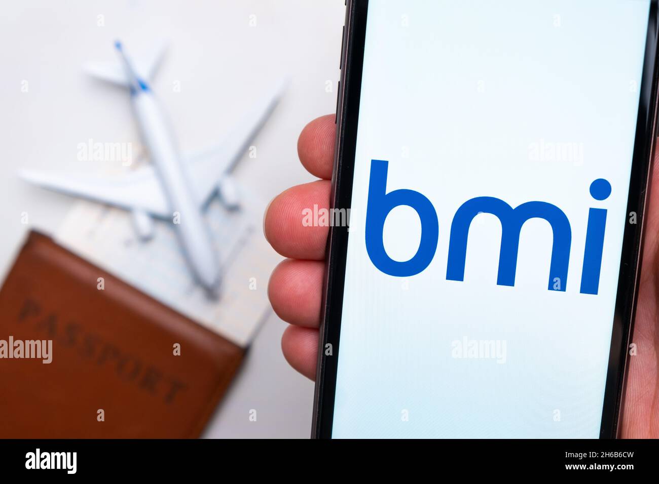 Bmi airlines company logo on the mobile phone screen in man hand on the ...