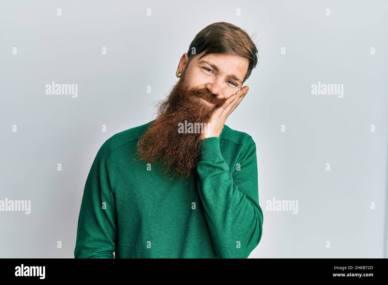 Redhead man with long beard wearing casual clothes thinking looking ...