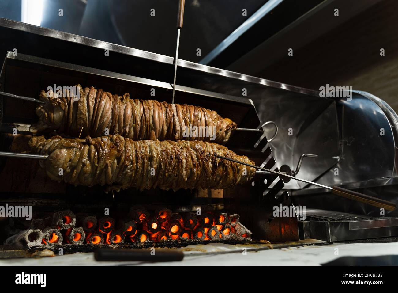 Kokorech lamb intestines roasting in Turkish market. Traditional street ...