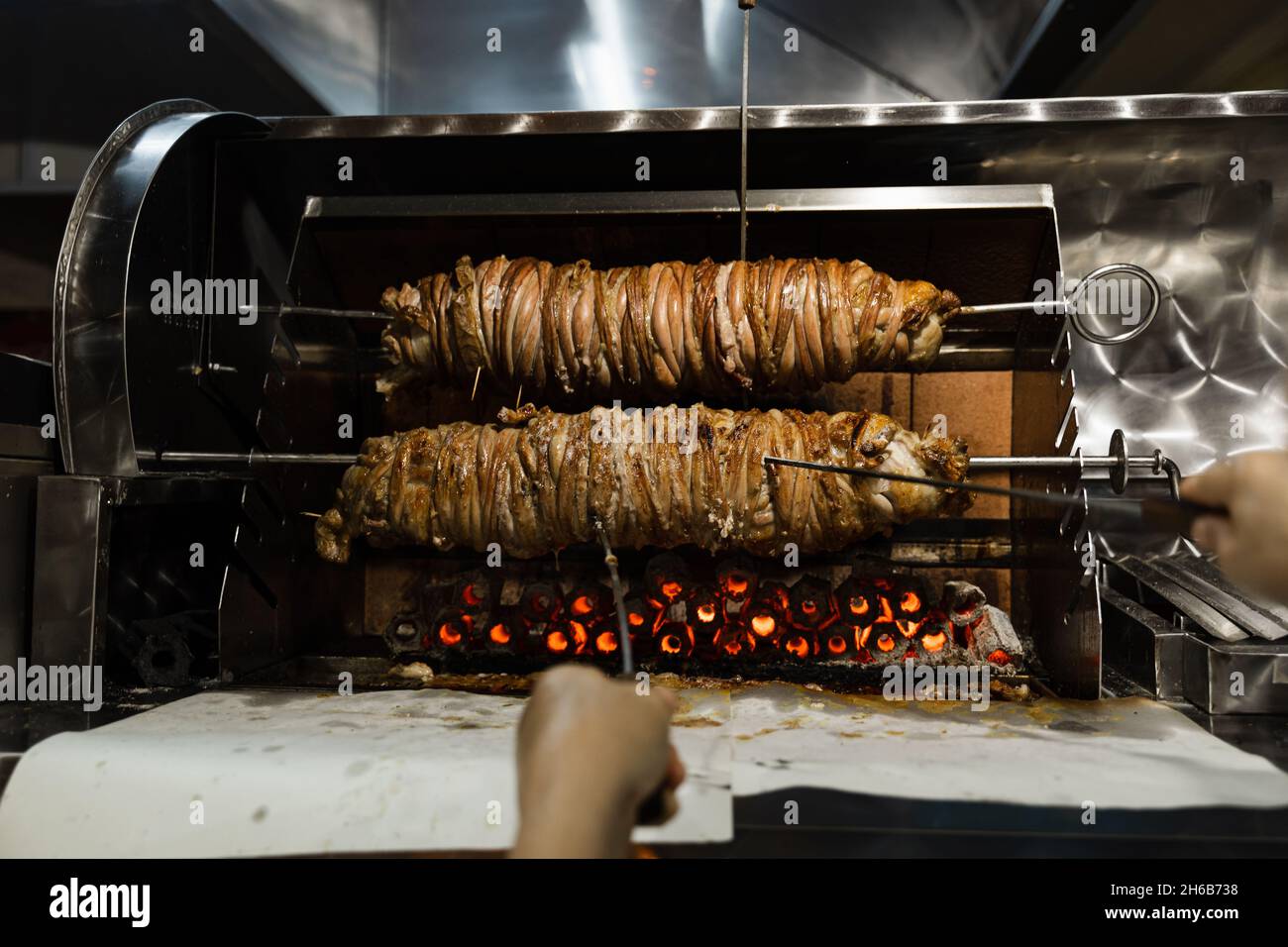 Kokorech lamb intestines roasting in Turkish market. Traditional street ...