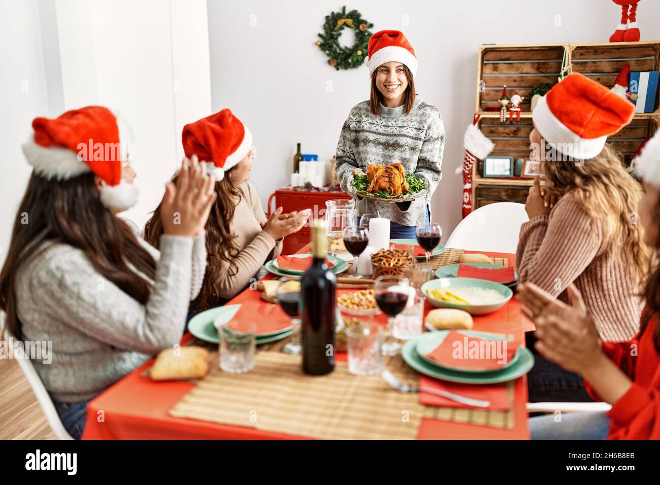 Group of hispanic women clapping and sitting on the table. Woman ...