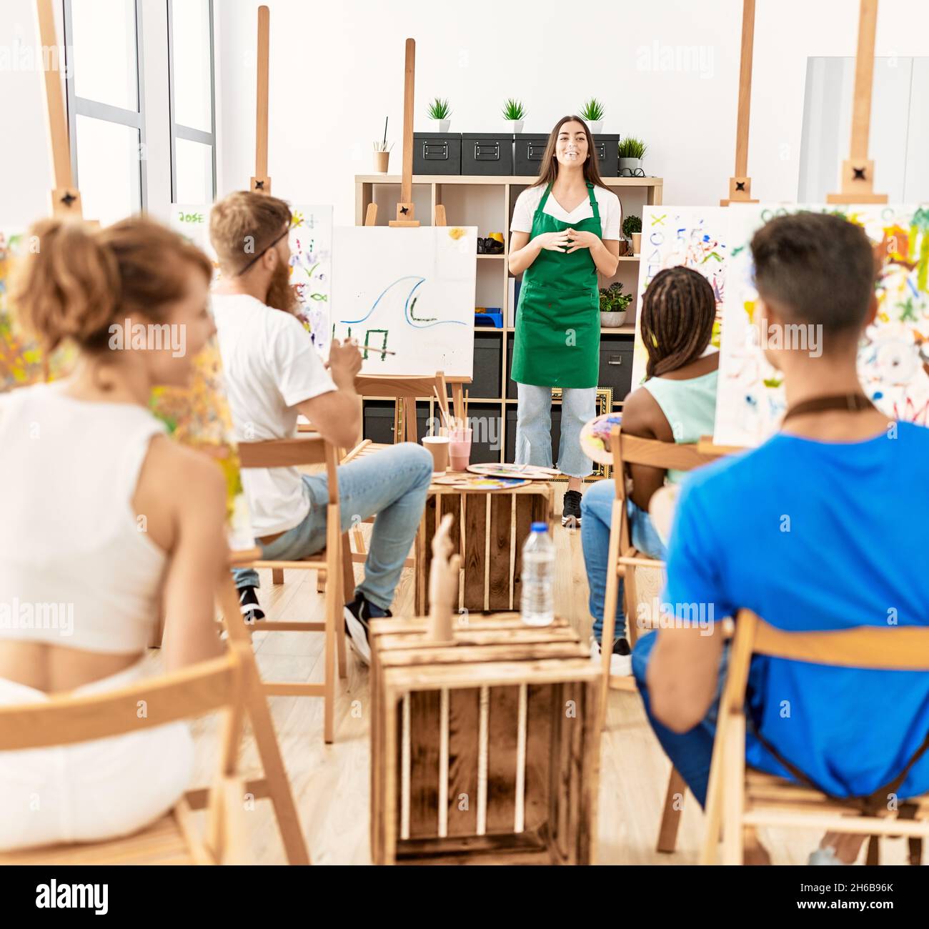 Group of people smiling happy drawing in paint class at art studio ...