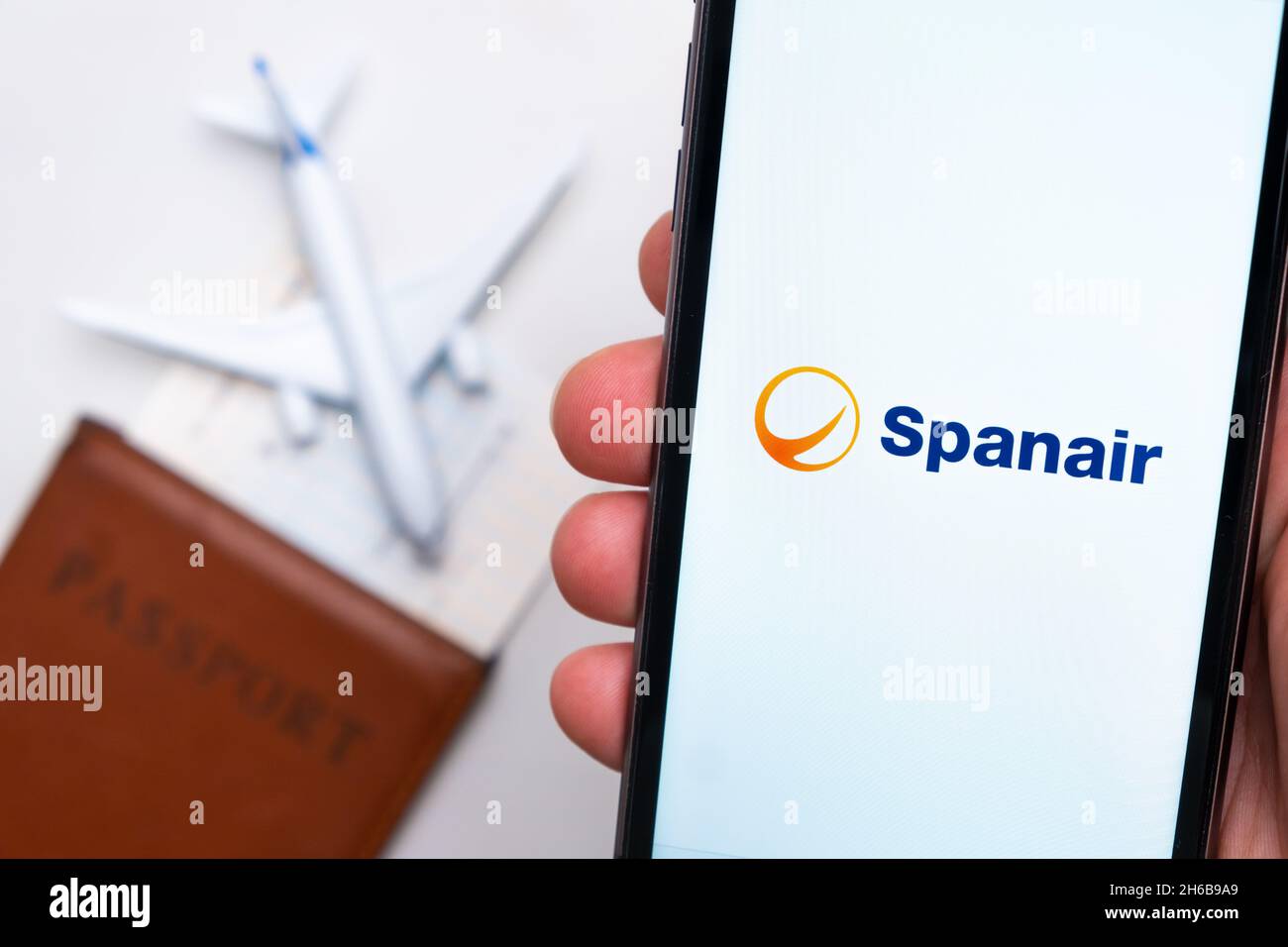 Spanair airlines company logo on the mobile phone screen in man hand on ...