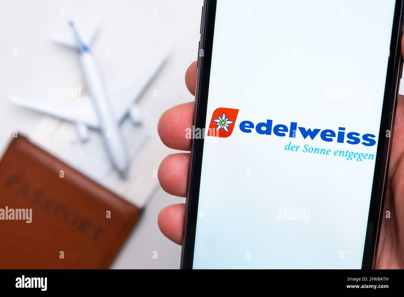 Edelweiss airlines company logo on the mobile phone screen in man hand ...