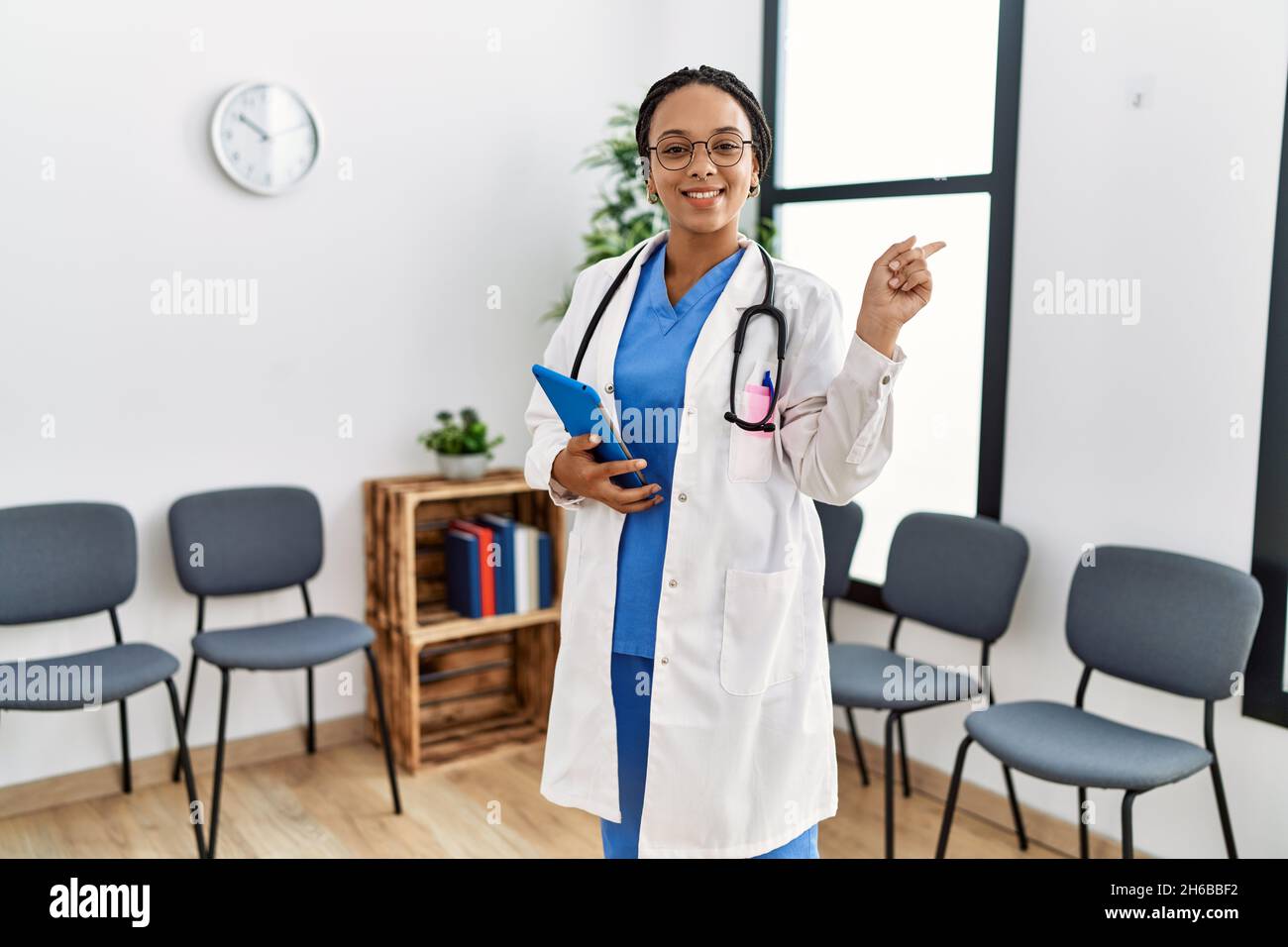 Young african american doctor woman at waiting room smiling happy ...