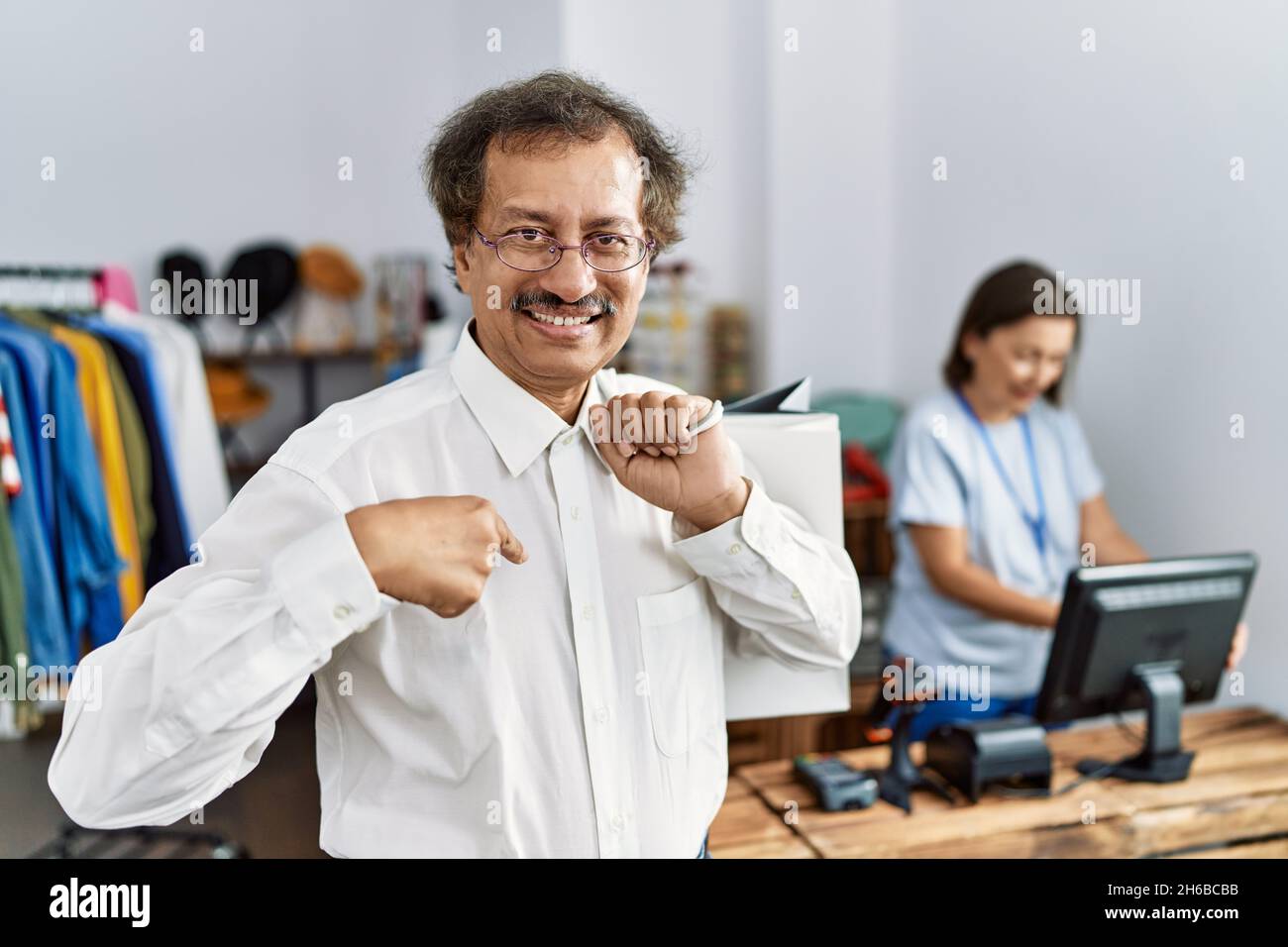Southeast asian man wearing holding shopping bags pointing finger to ...