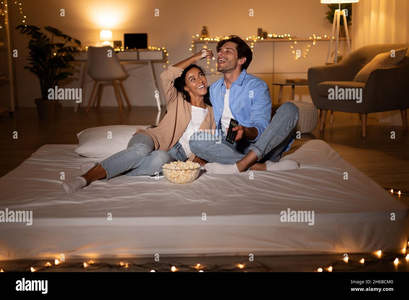 Couple sitting on bed eating hi-res stock photography and images - Alamy