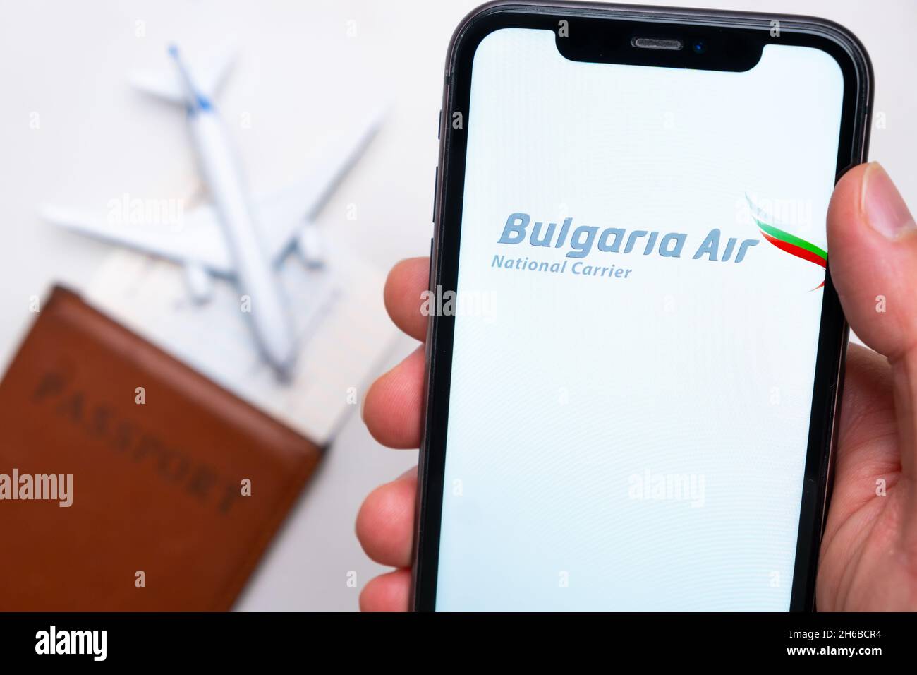Bulgaria Air Airlines app on the cell phone screen in mans hand with ...
