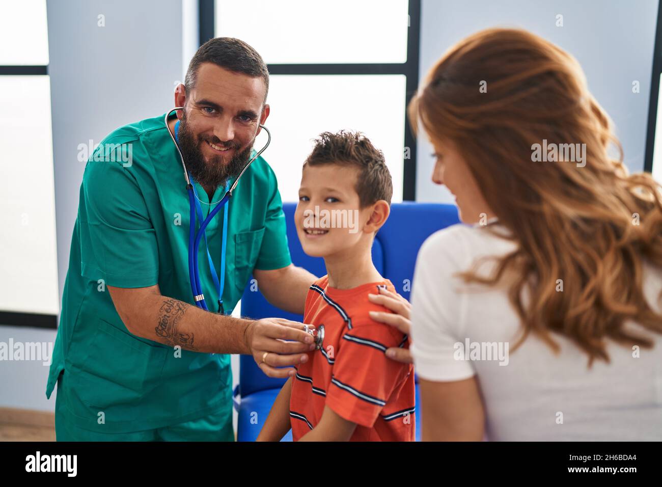 Family having medical consultation auscultating heart at clinic Stock ...