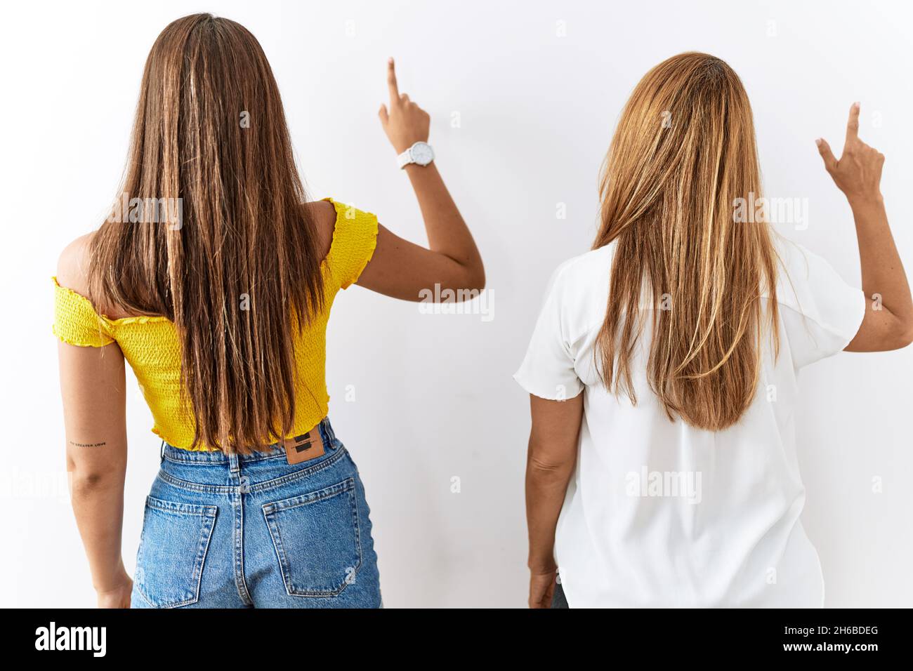 Mother and daughter together standing together over isolated background ...