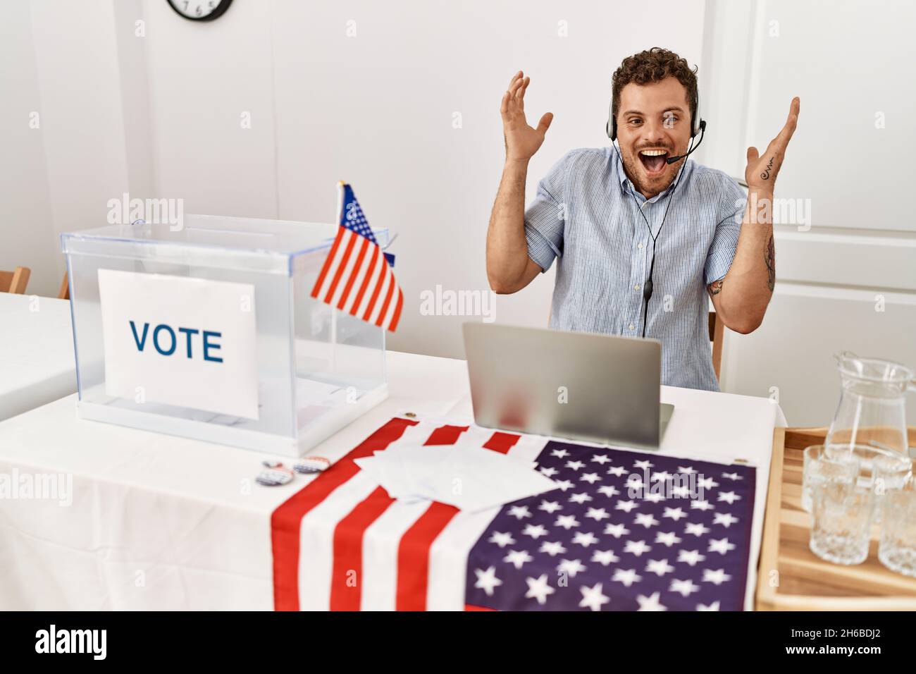 Handsome young man working at political campaign wearing operator head ...