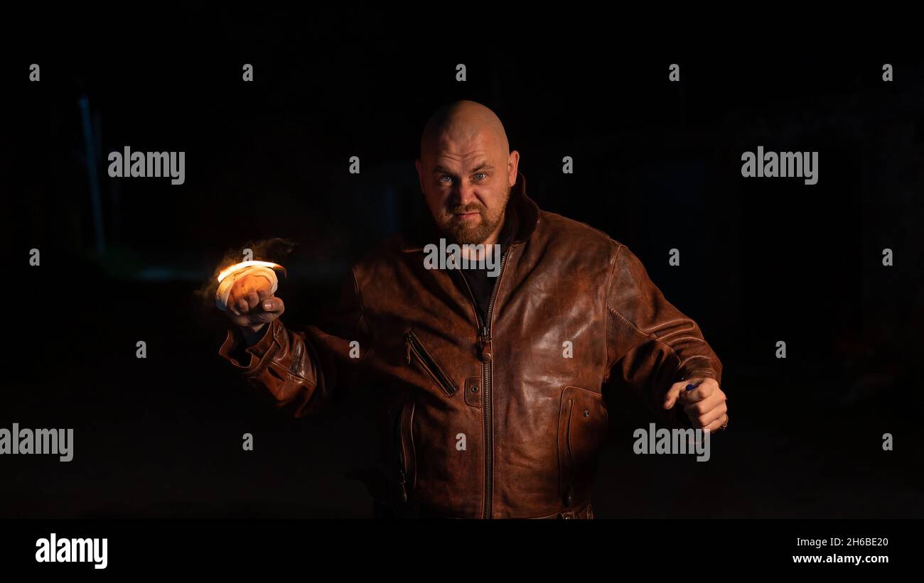 Bald Caucasian man beats with a burning fist Stock Photo - Alamy
