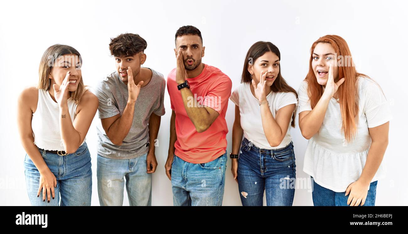 Group of young friends standing together over isolated background hand ...