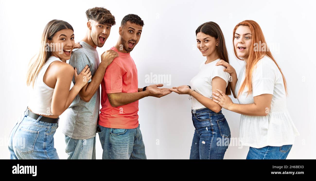 Group of young friends standing together over isolated background ...