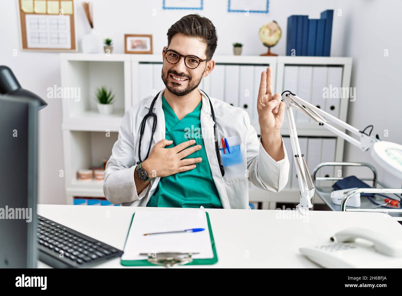 Young man with beard wearing doctor uniform and stethoscope at the ...