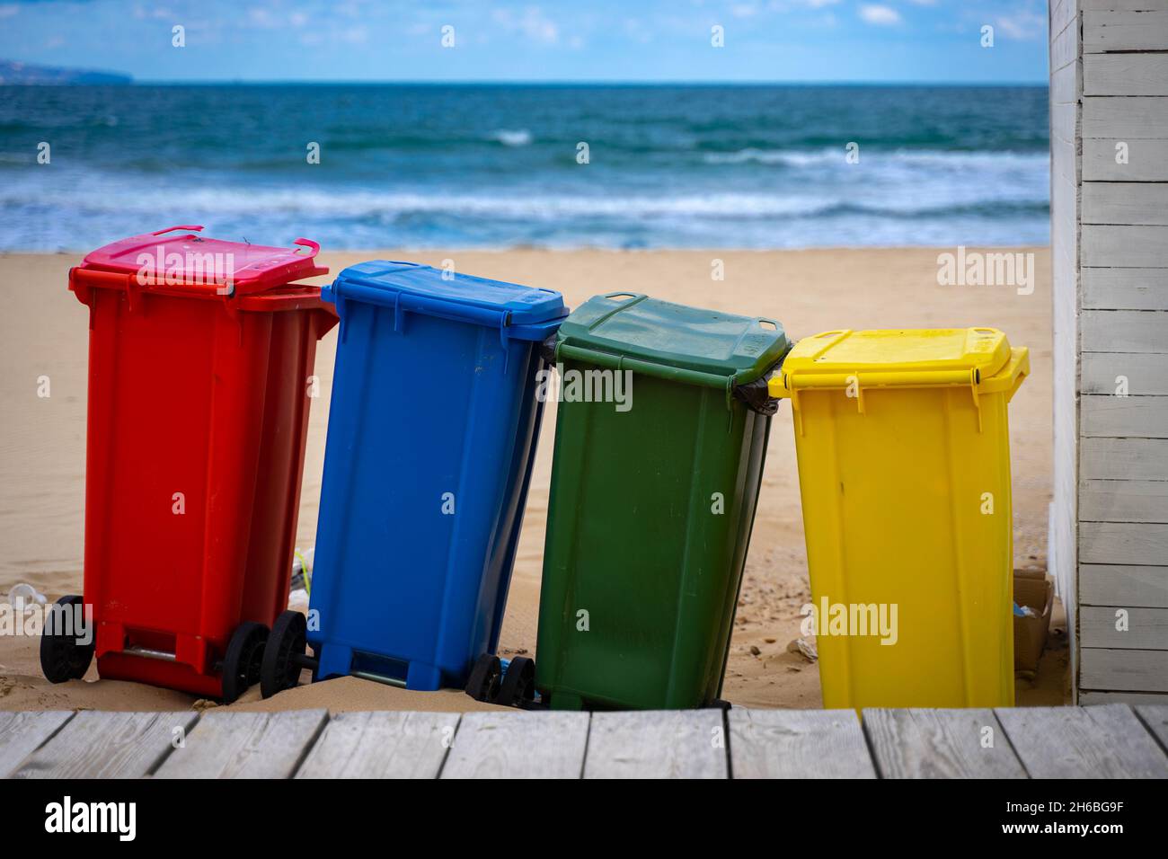 Colorful trash bins on the Sunny Beach with the sea in the background ...