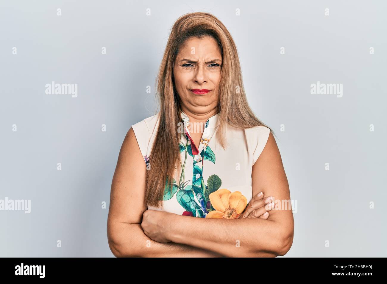 Middle age hispanic woman wearing casual clothes skeptic and nervous ...