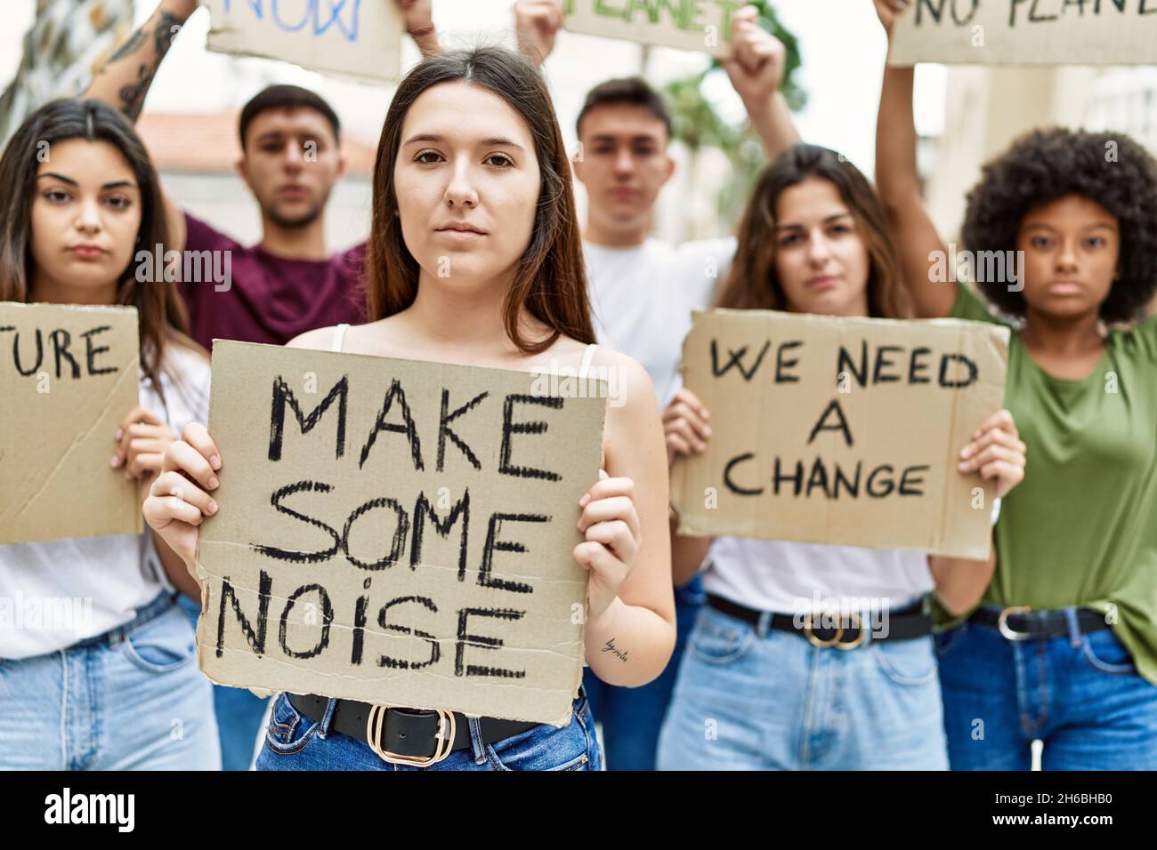Group of young activists people holding protest banner protesting at ...