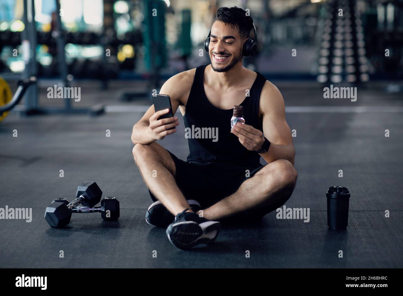 Snack Break. Smiling Young Arab Man Resting At Gym After Training ...