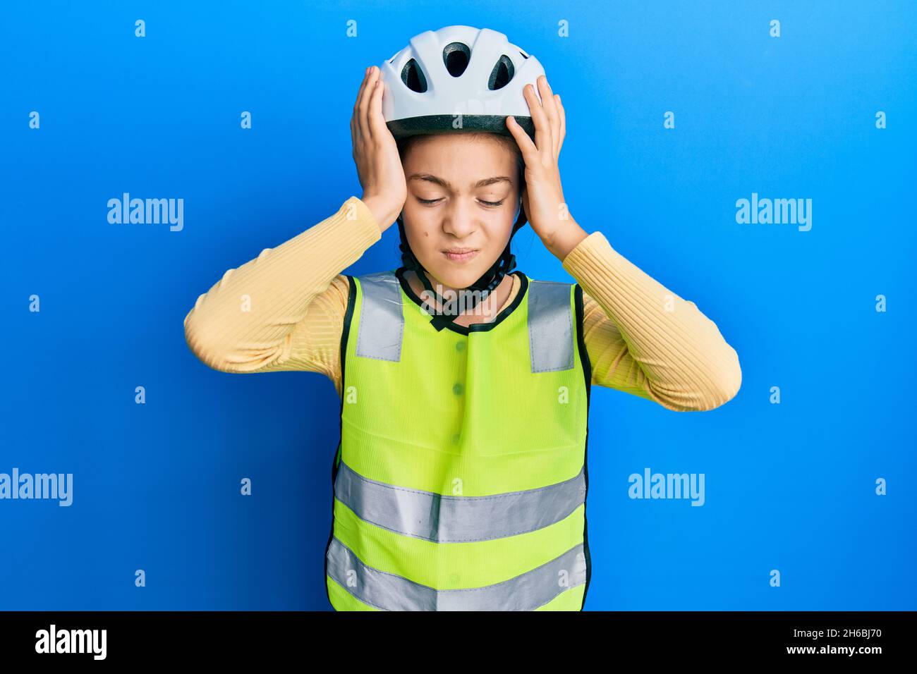 Beautiful brunette little girl wearing bike helmet and reflective vest ...