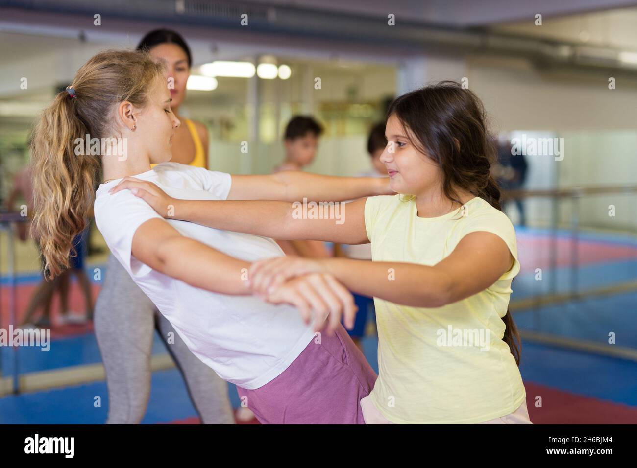 Two school girls practicing self-defense moves Stock Photo - Alamy