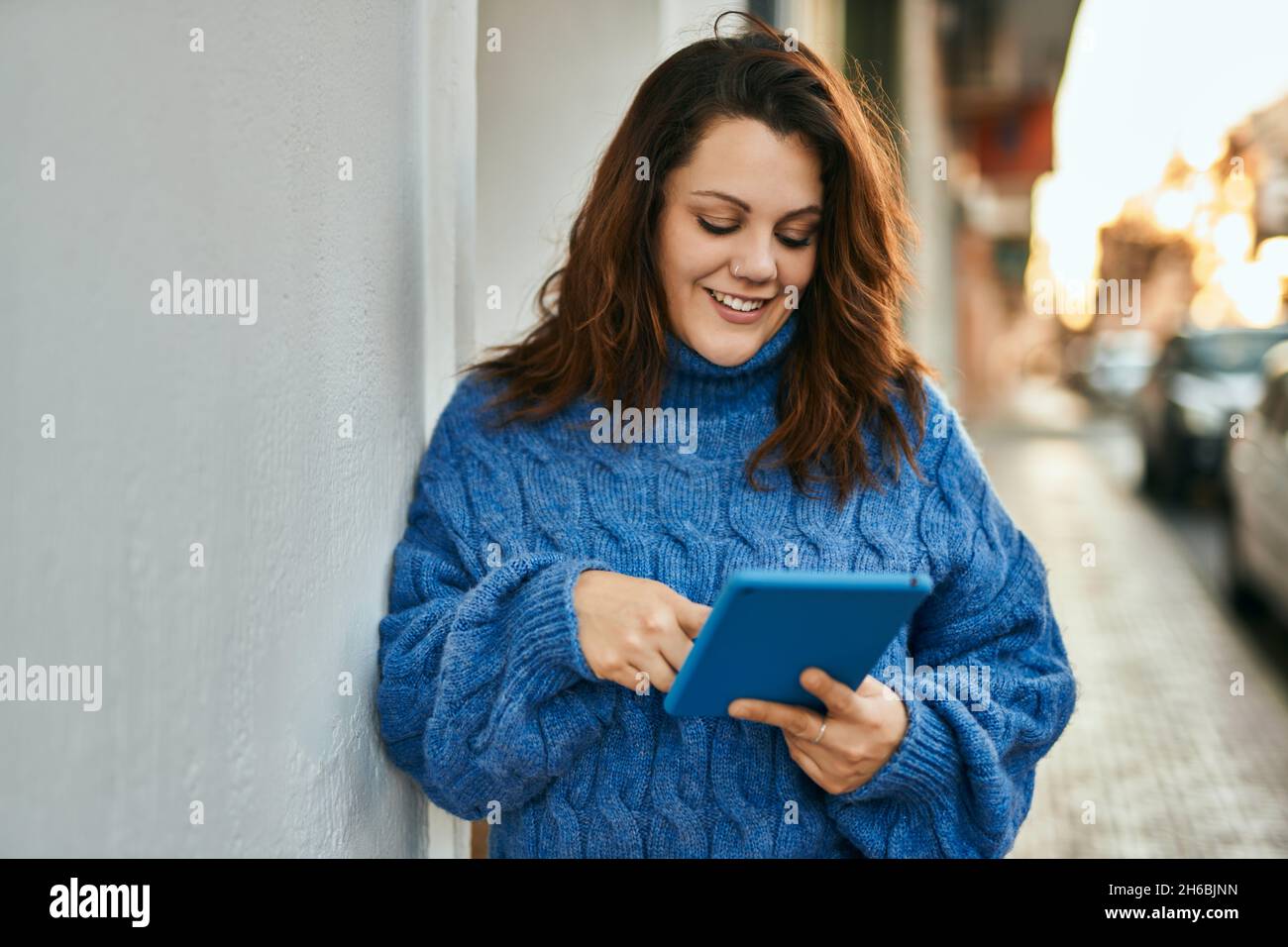 Young irish plus size girl using touchpad at the city Stock Photo - Alamy