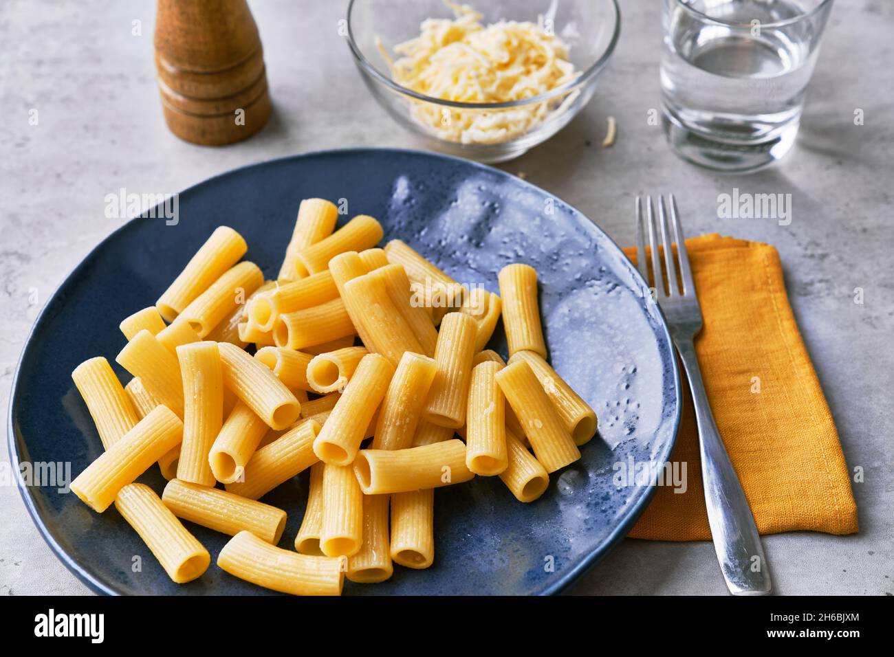 Plate of macaroni italian pasta on a concrete surface Stock Photo - Alamy