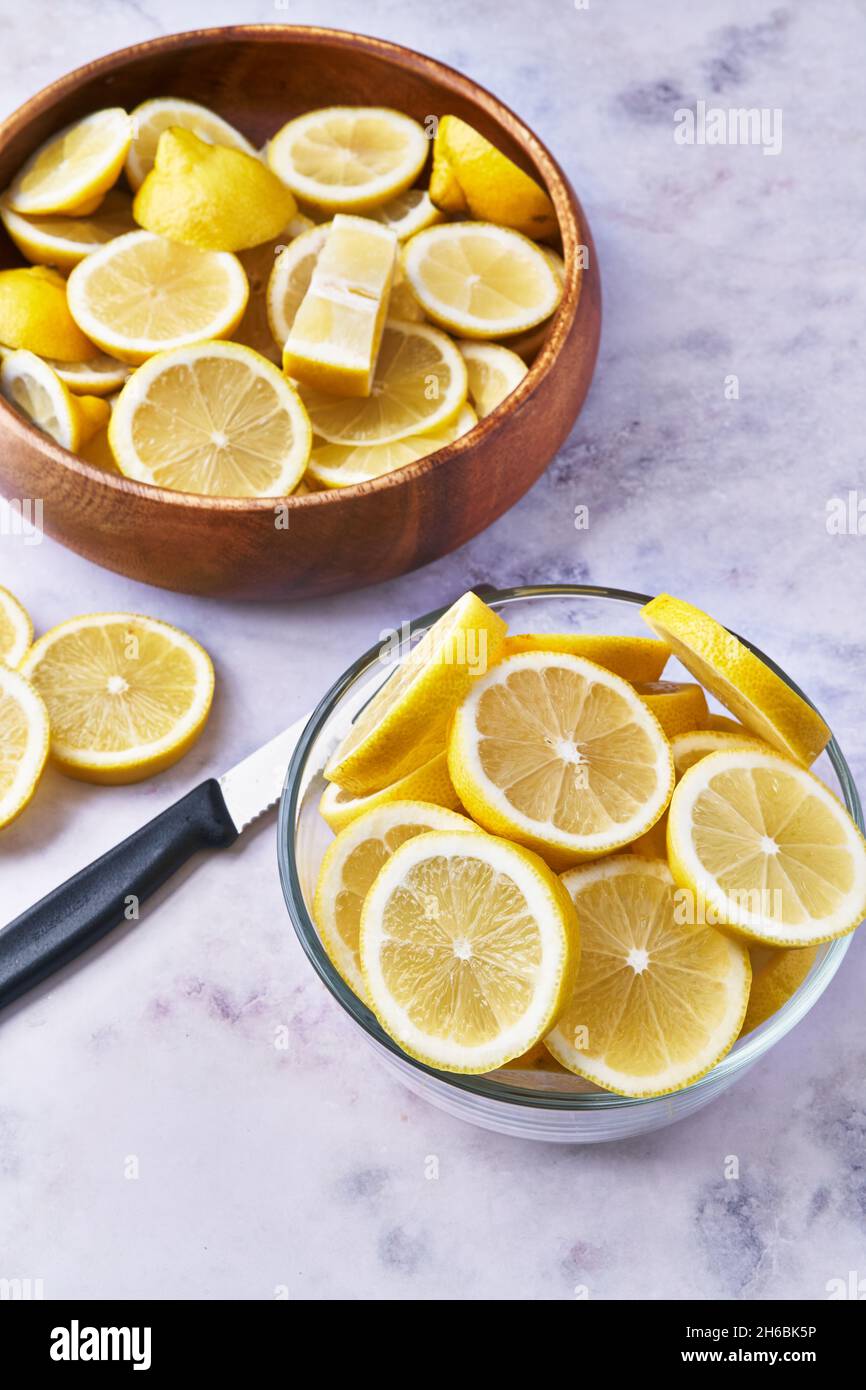 Bowls of slices of lemon on a marble surface Stock Photo - Alamy