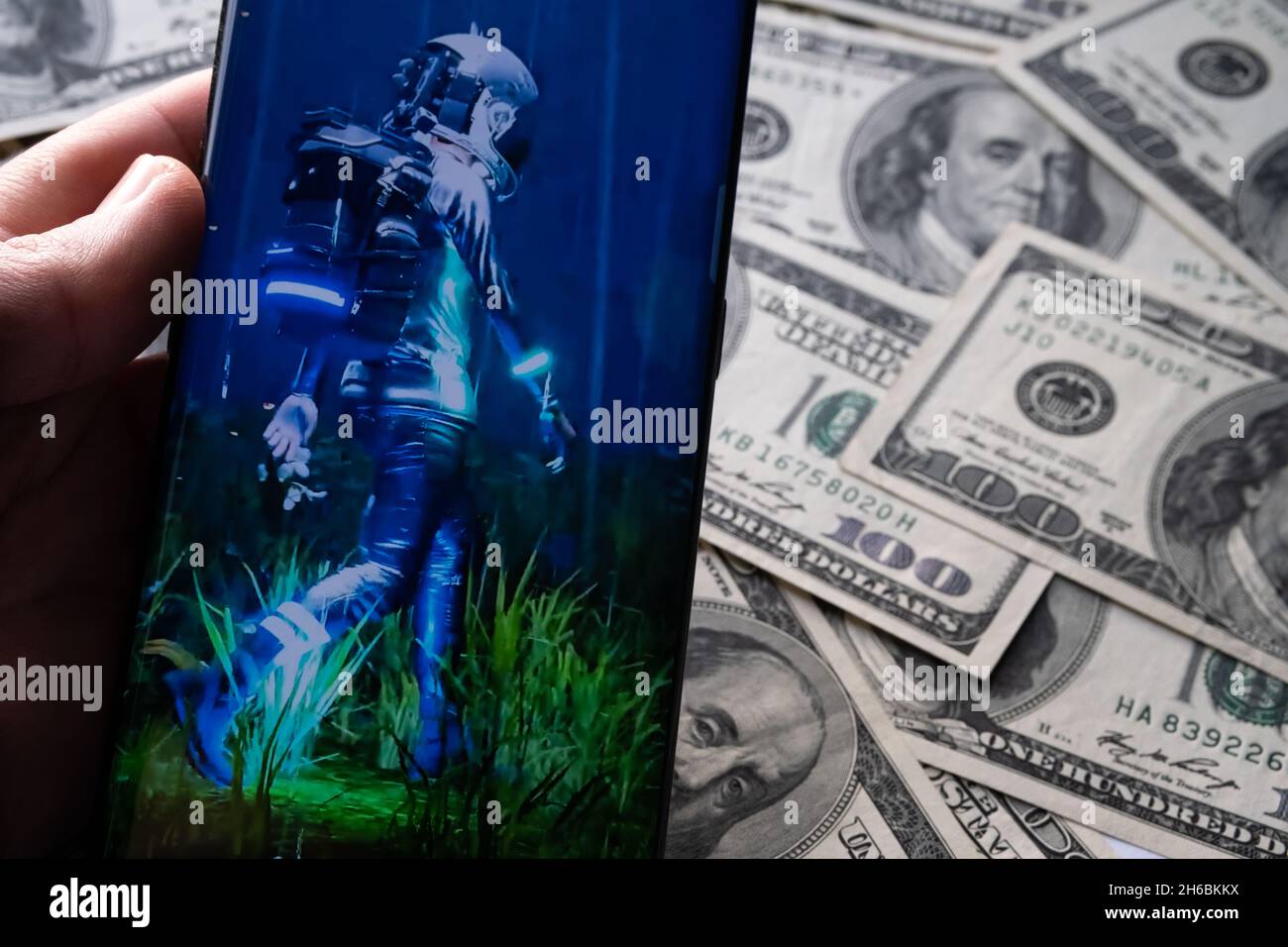 Beeple's 'HUMAN ONE' NFT stop frame image seen on smartphone and dollar ...