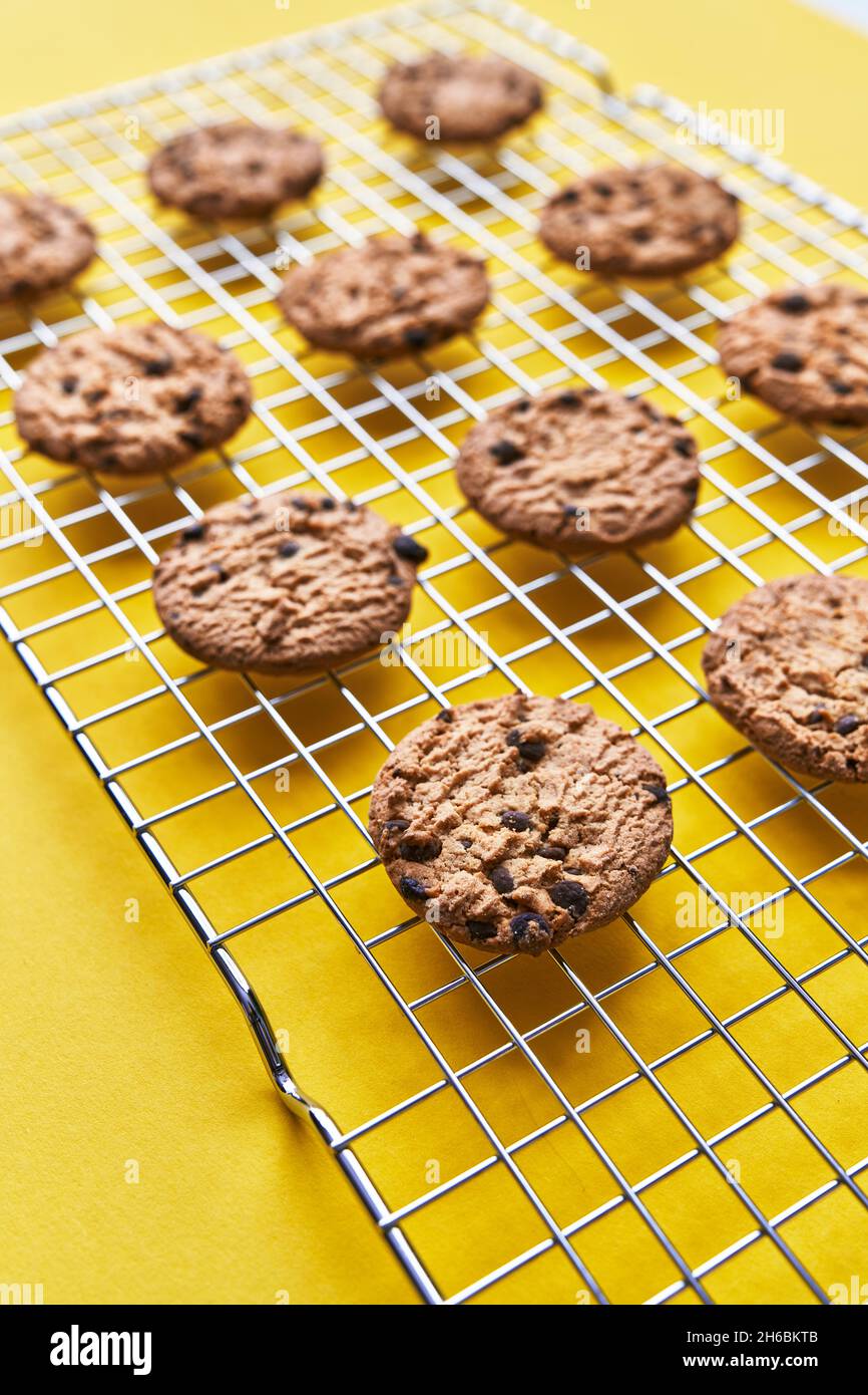 Chocolate cookies served on a grid rack on a yellow background Stock ...