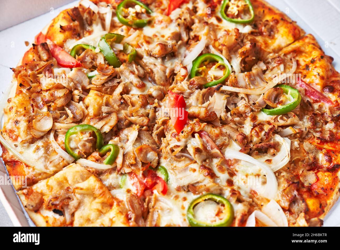 Delicious kebab italian pizza on a cardboard surface Stock Photo - Alamy
