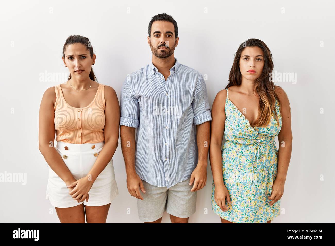 Group of young hispanic people standing over isolated background with ...