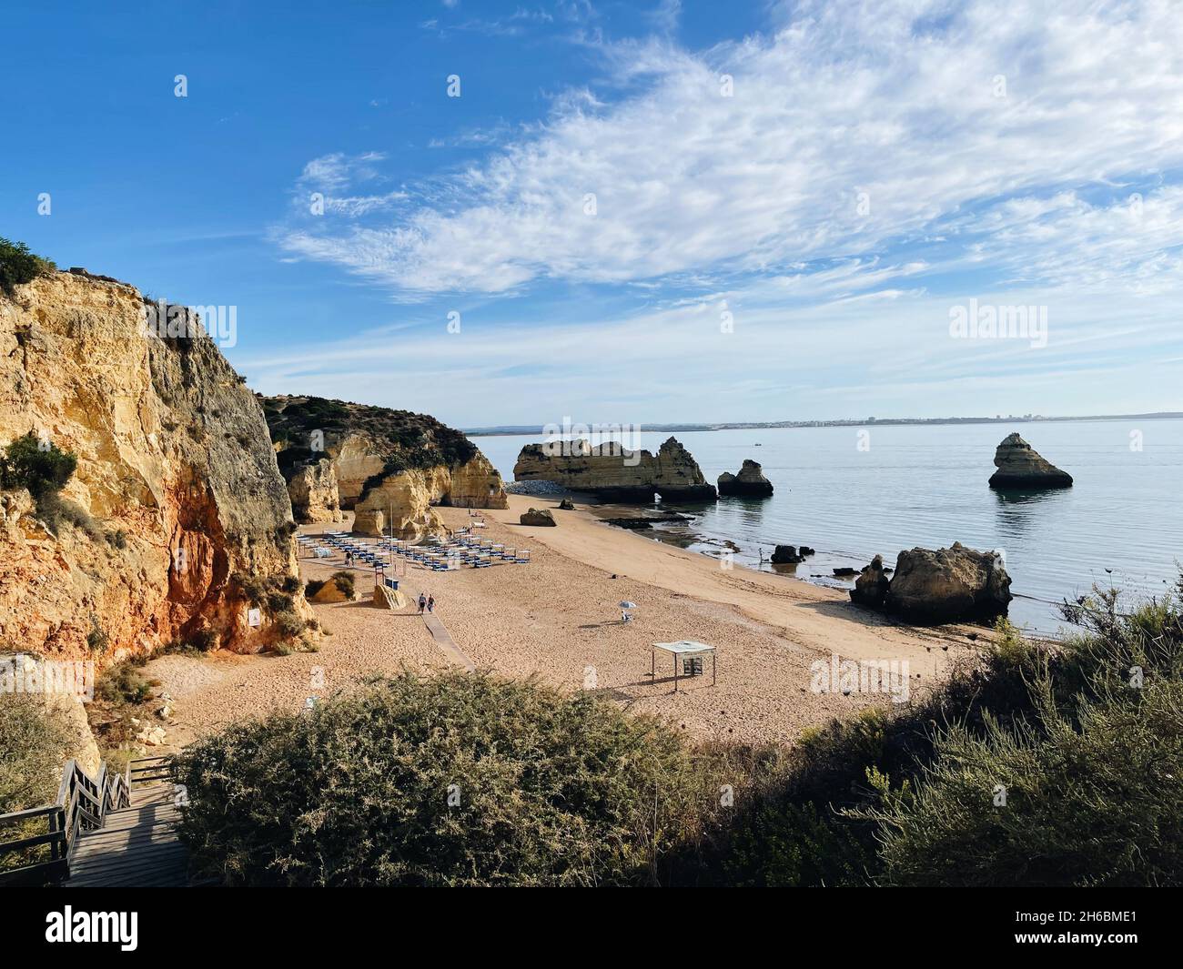 Praia Dona Ana beach with turquoise sea water and cliffs, flying ...
