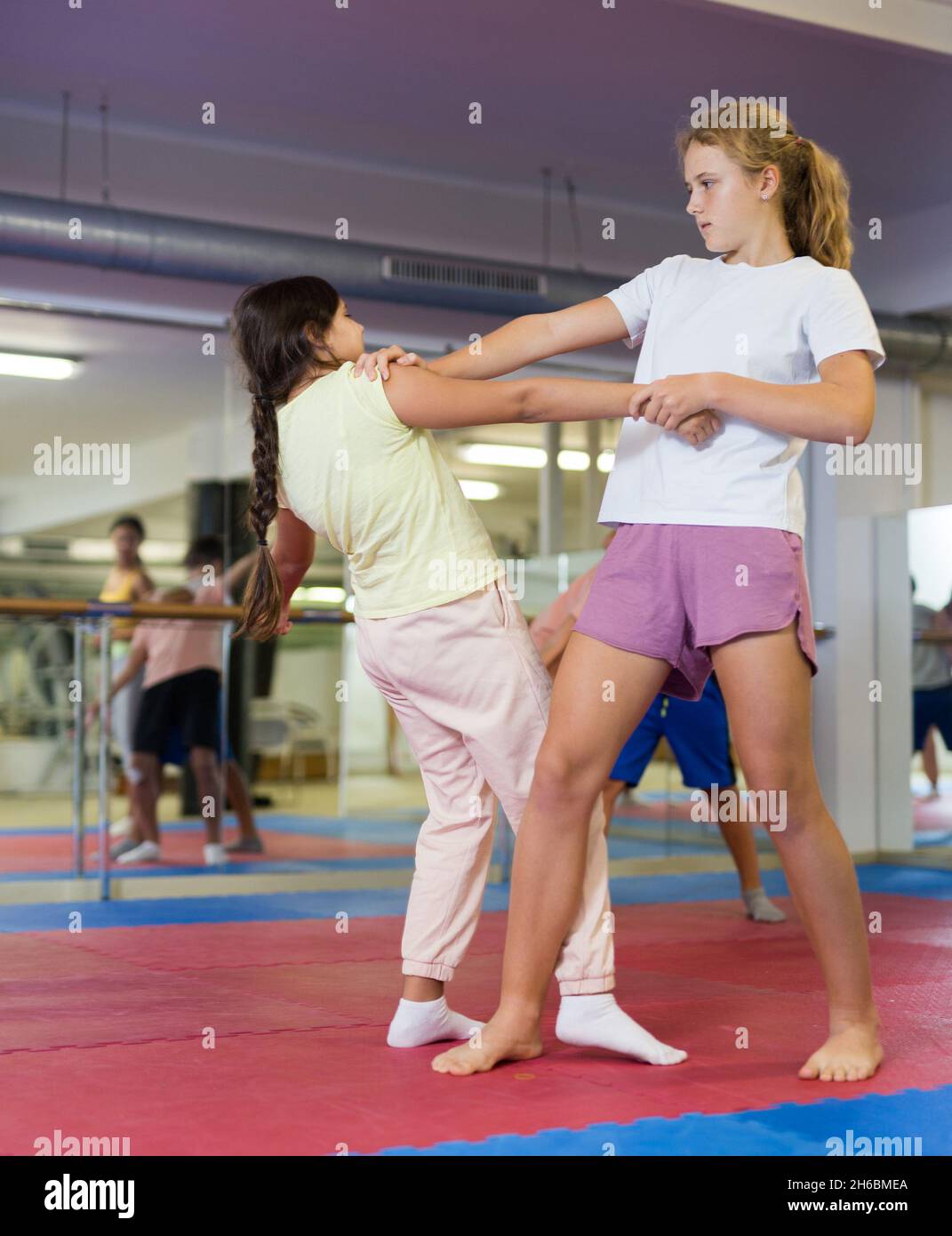 Kids learning self-defence moves in gym Stock Photo - Alamy