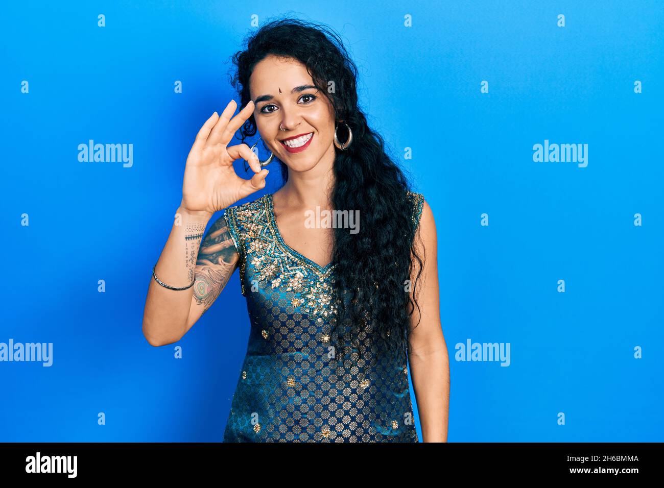 Young woman wearing bindi and traditional kurta dress smiling positive ...