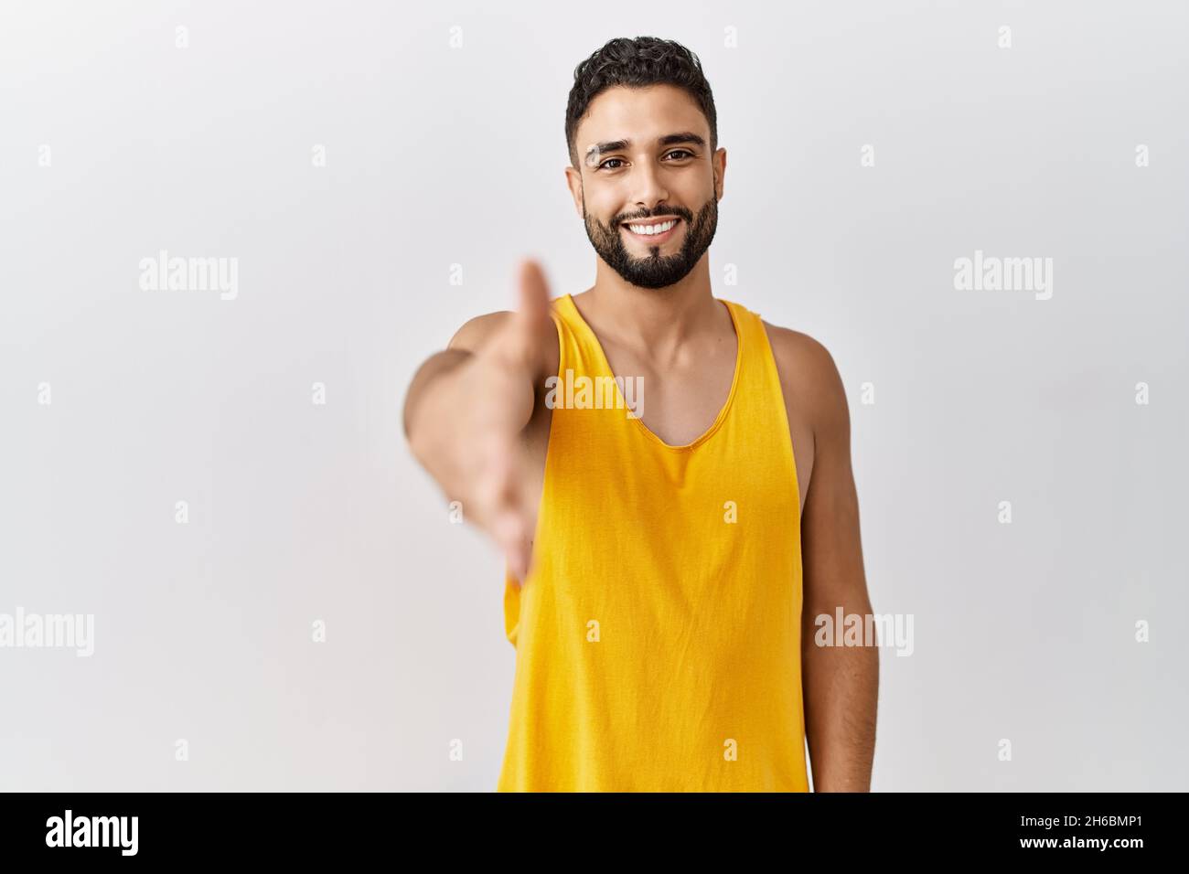 Young handsome man with beard standing over isolated background smiling ...