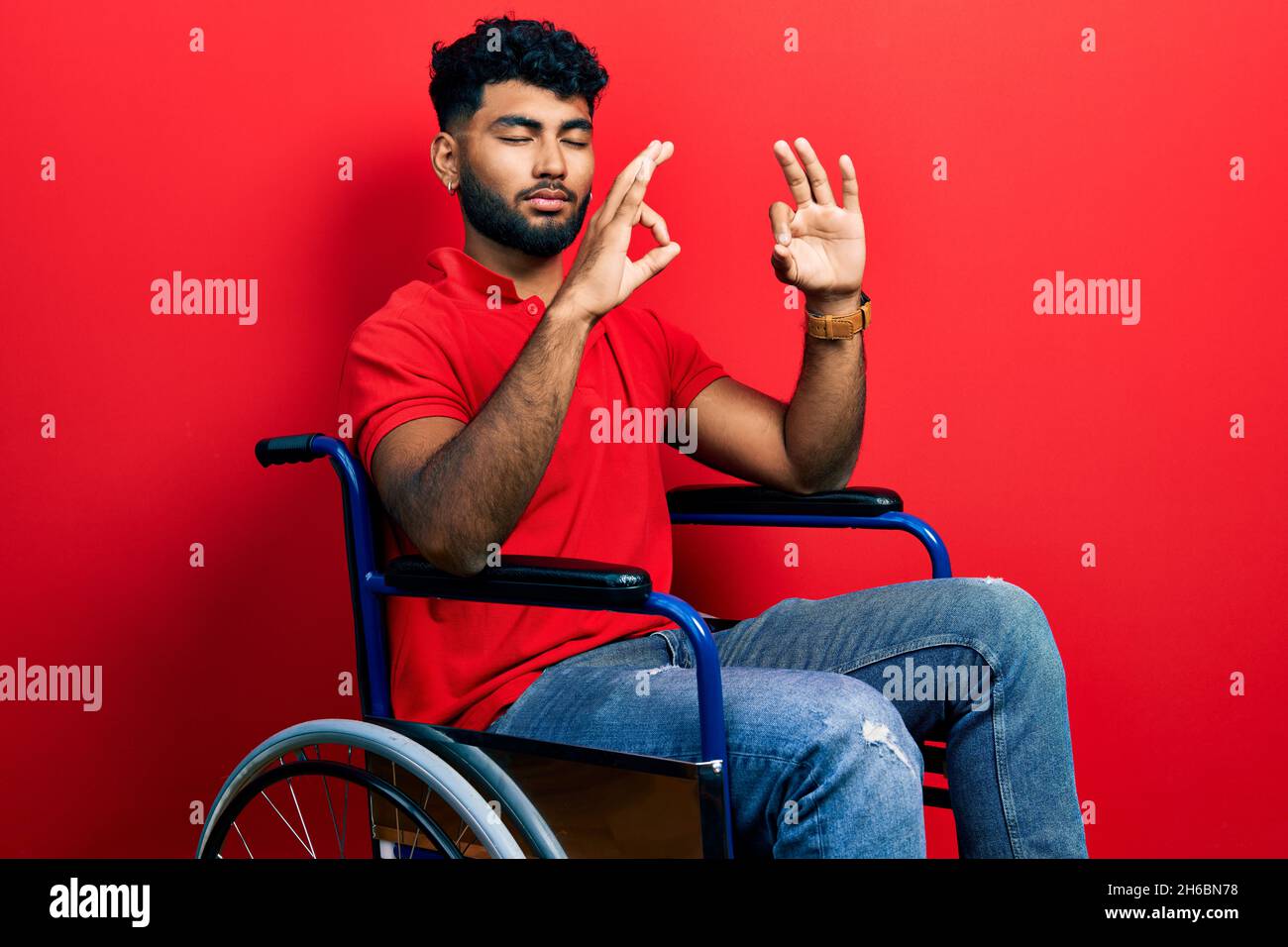 Arab man with beard sitting on wheelchair relaxed and smiling with eyes ...