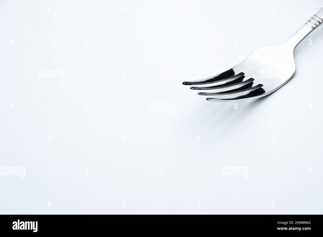Single fork isolated on white background with subtle shadow Stock Photo ...