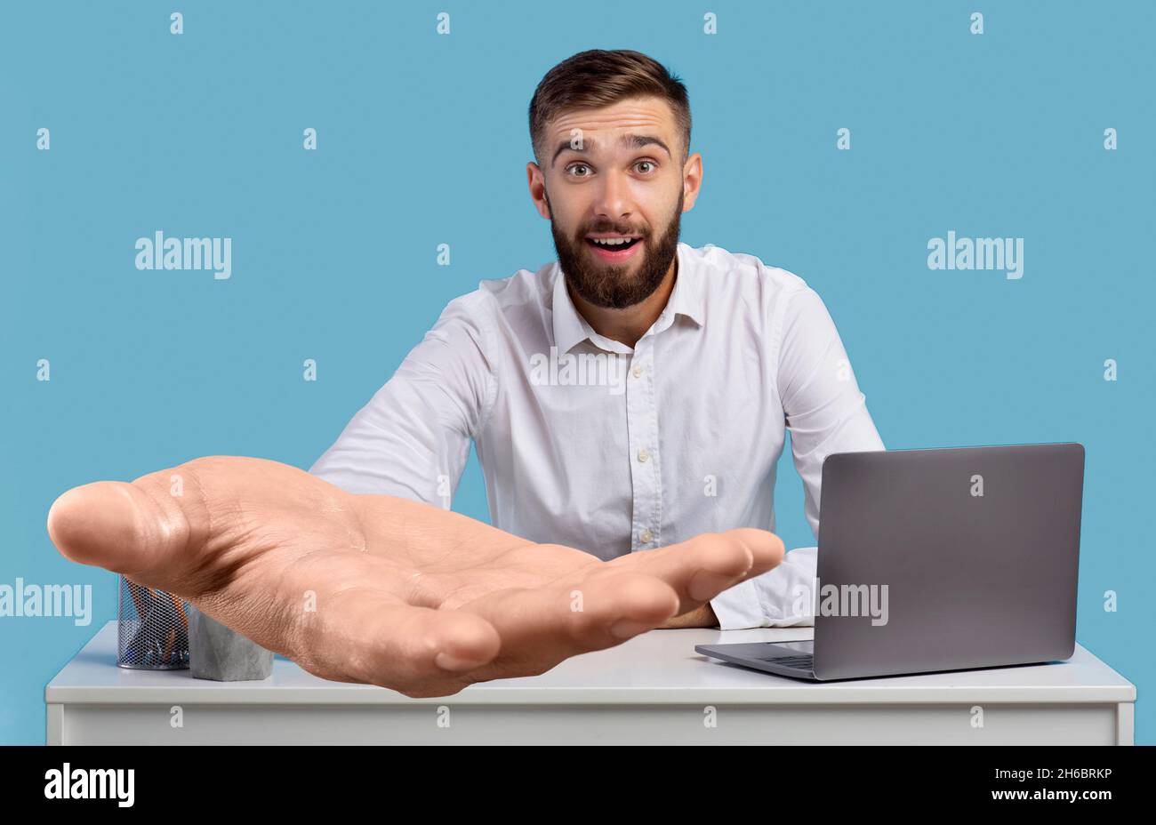 Surprised young guy in formal outfit businessman sitting at worktable ...