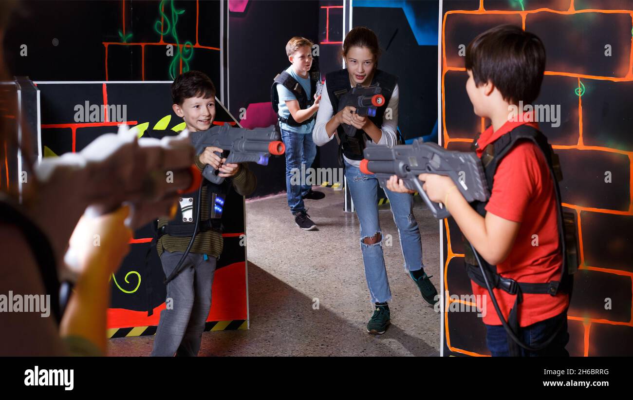 Fine kids aiming laser guns at other players Stock Photo - Alamy