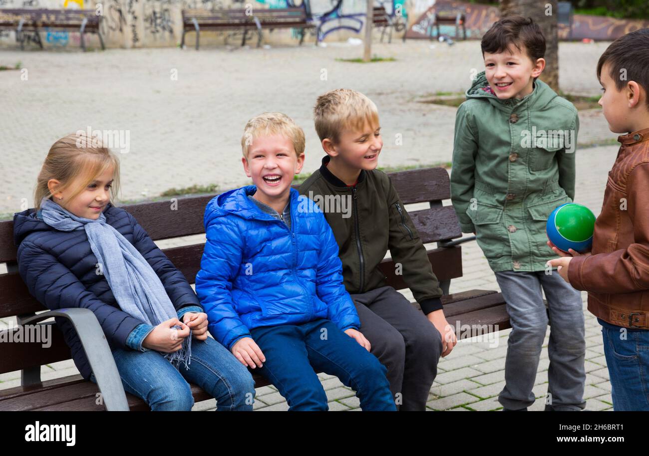Children playing with ball on bench Stock Photo - Alamy