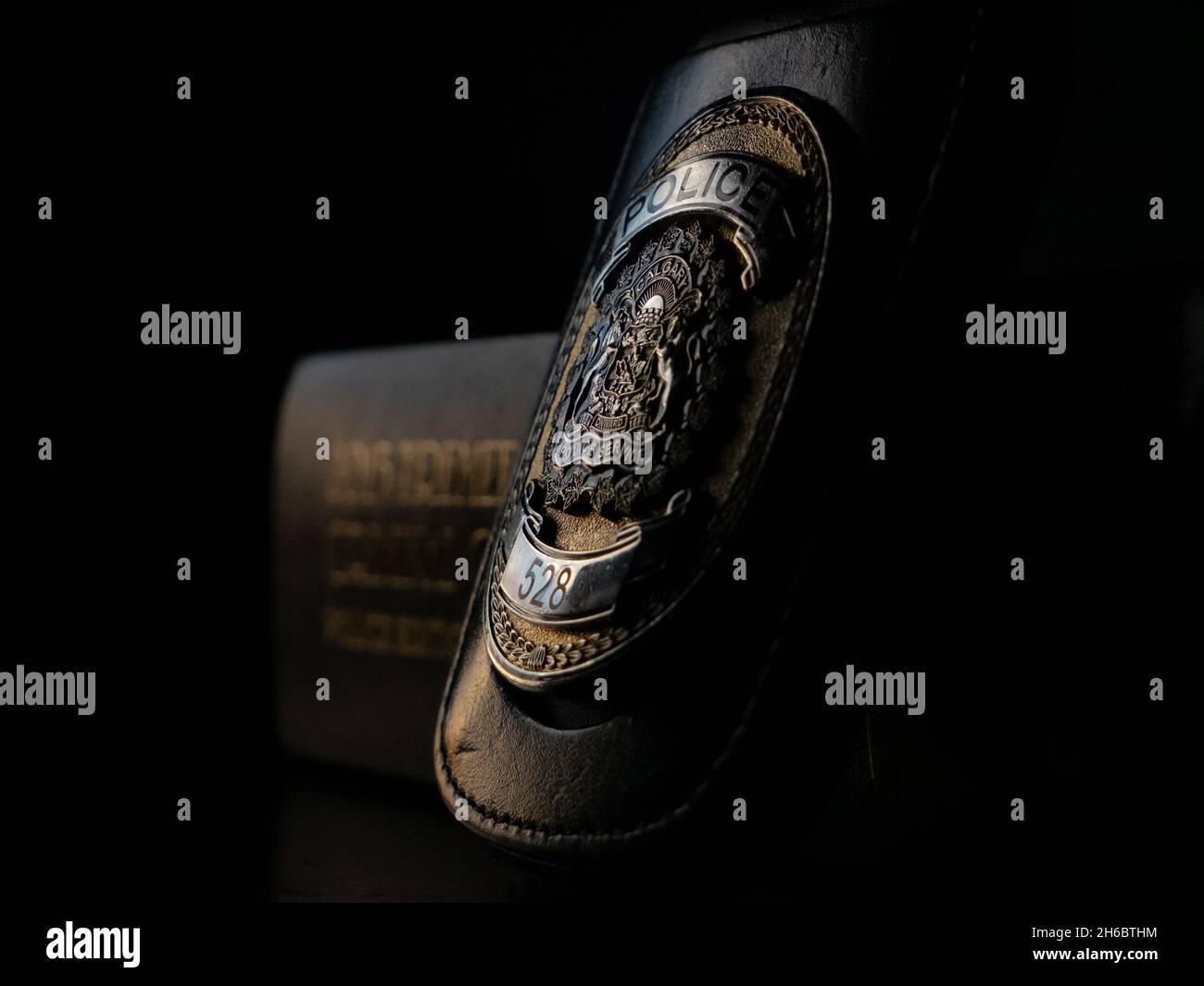 A close-up shot of a police badge leaning against the Criminal Code ...